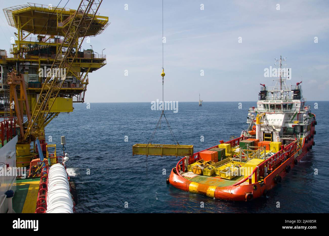 Oil rigs with supply boat boat for transporting people or materials to ...