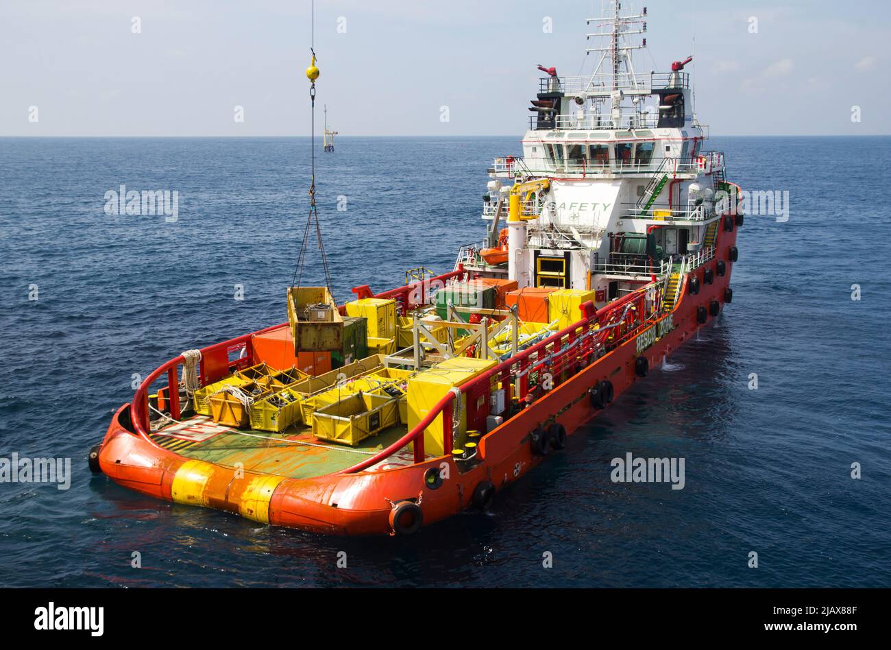 Oil rigs with supply boat boat for transporting people or materials to ...