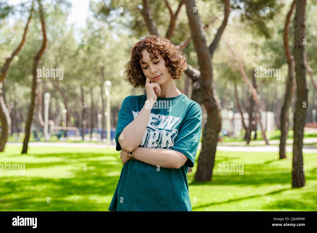 Young Redhead Woman Wearing Green T Shirt Standing On City Park