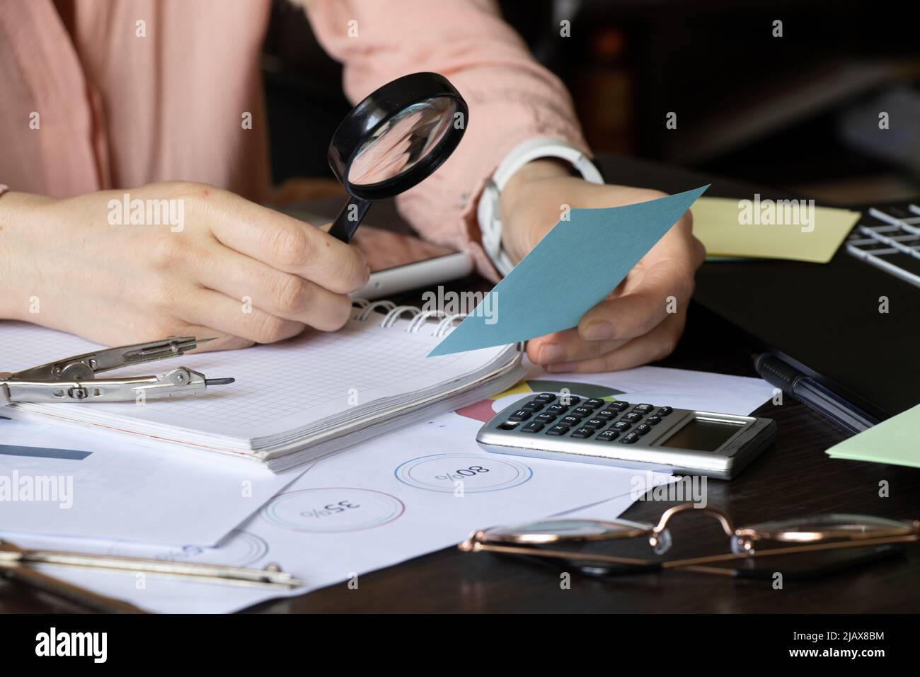 The girl sits at her desk and draws up graphs and histograms about ...