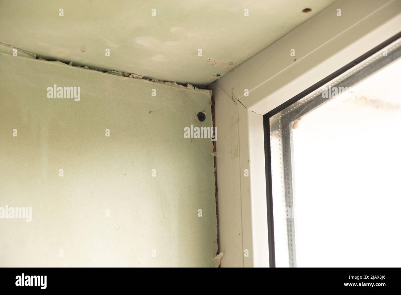windows with plasterboard slopes, moisture and fungus, apartment ...