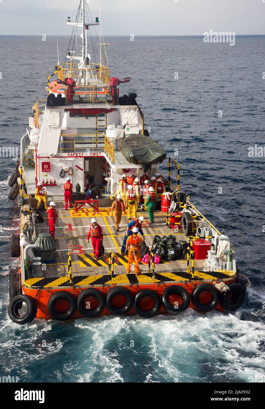 Oil rigs with supply boat boat for transporting people or materials to ...