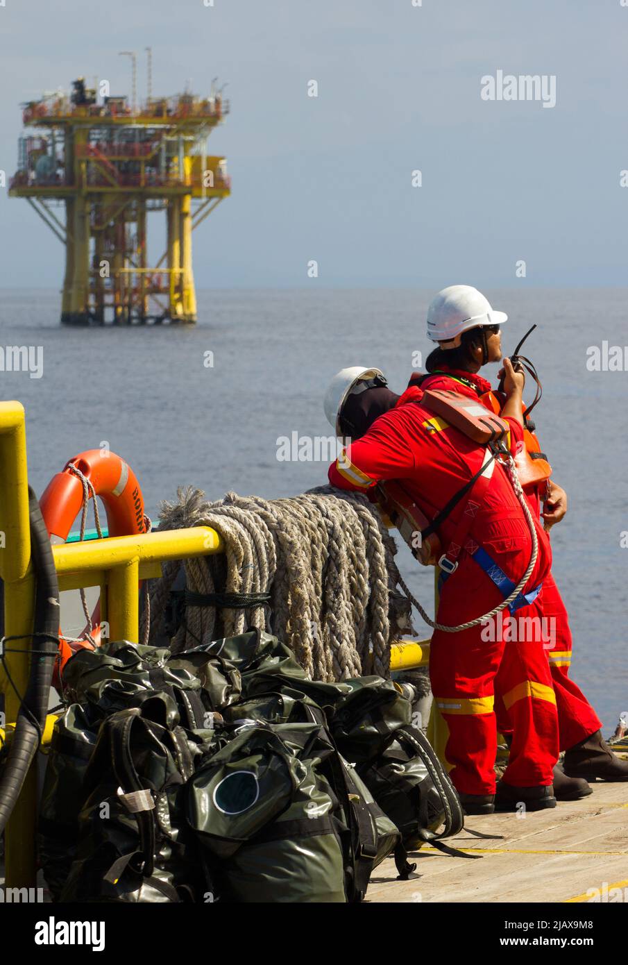 Oil rigs with supply boat boat for transporting people or materials to ...
