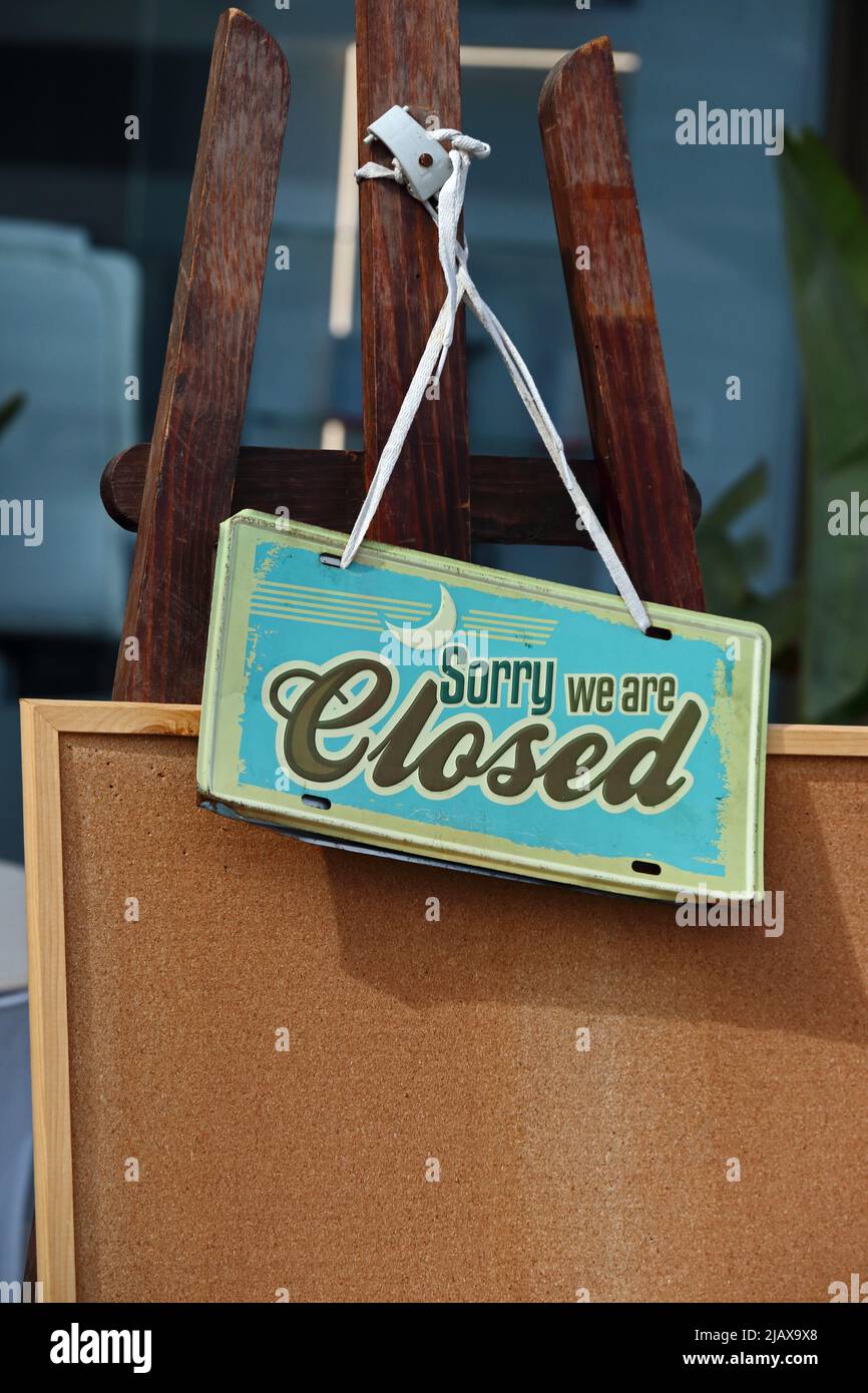 "Sorry we are closed" sign hanging from easel Stock Photo - Alamy