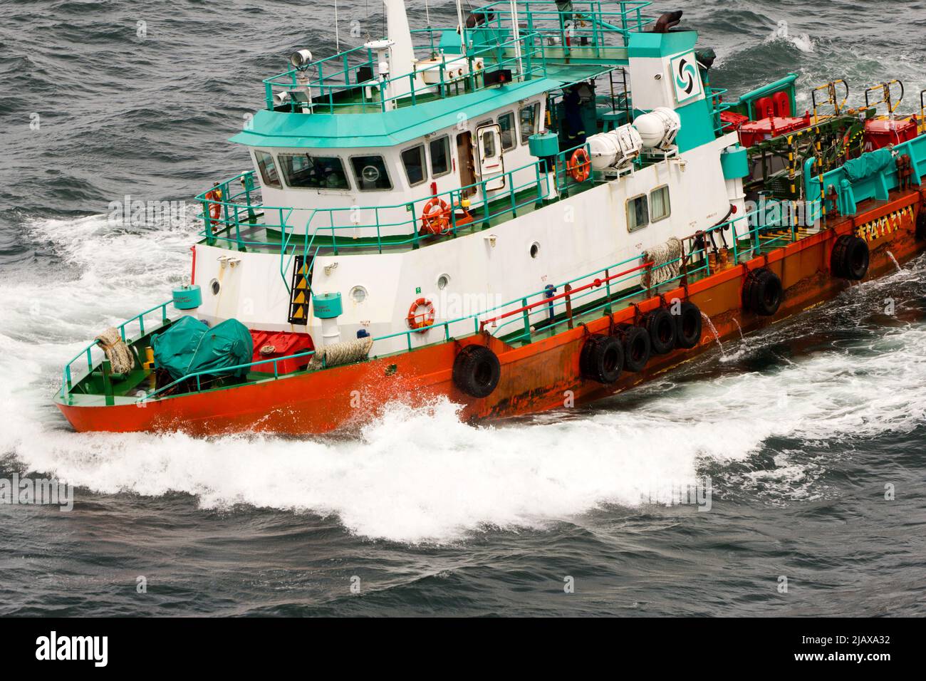 Oil rigs with supply boat boat for transporting people or materials to ...