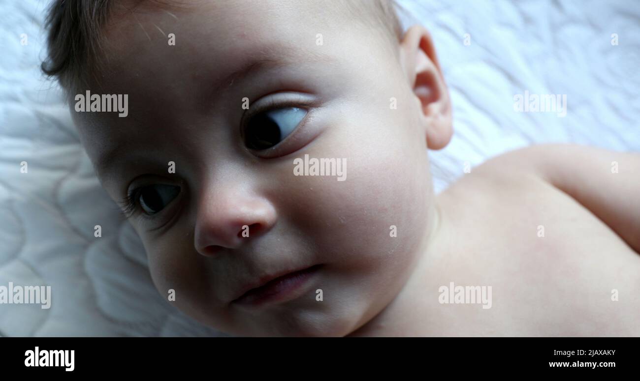 Cute baby infant toddler face looking around Stock Photo - Alamy
