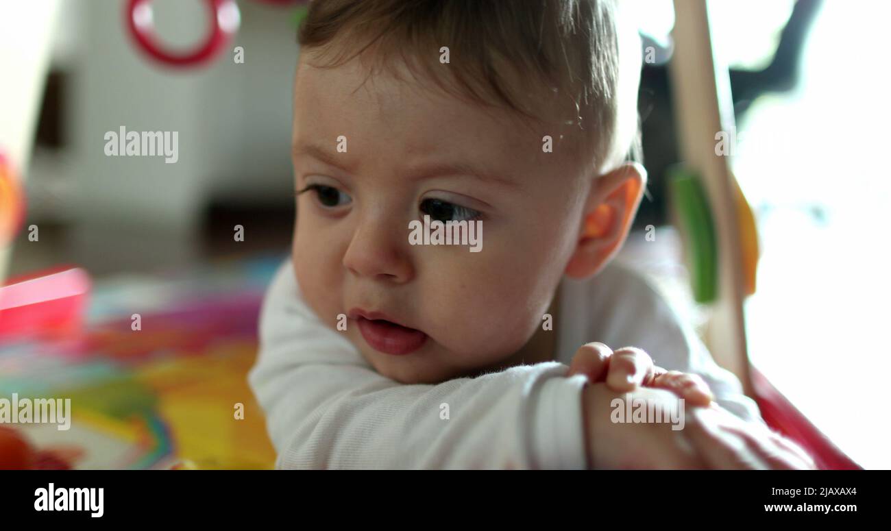 Cute baby playing with toy indoors. Close-up adorable child plays ...