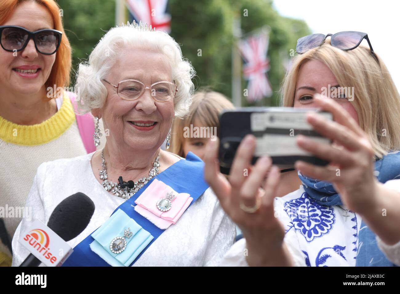 A lookalike of Queen Elizabeth II, walks down The Mall near Buckingham ...