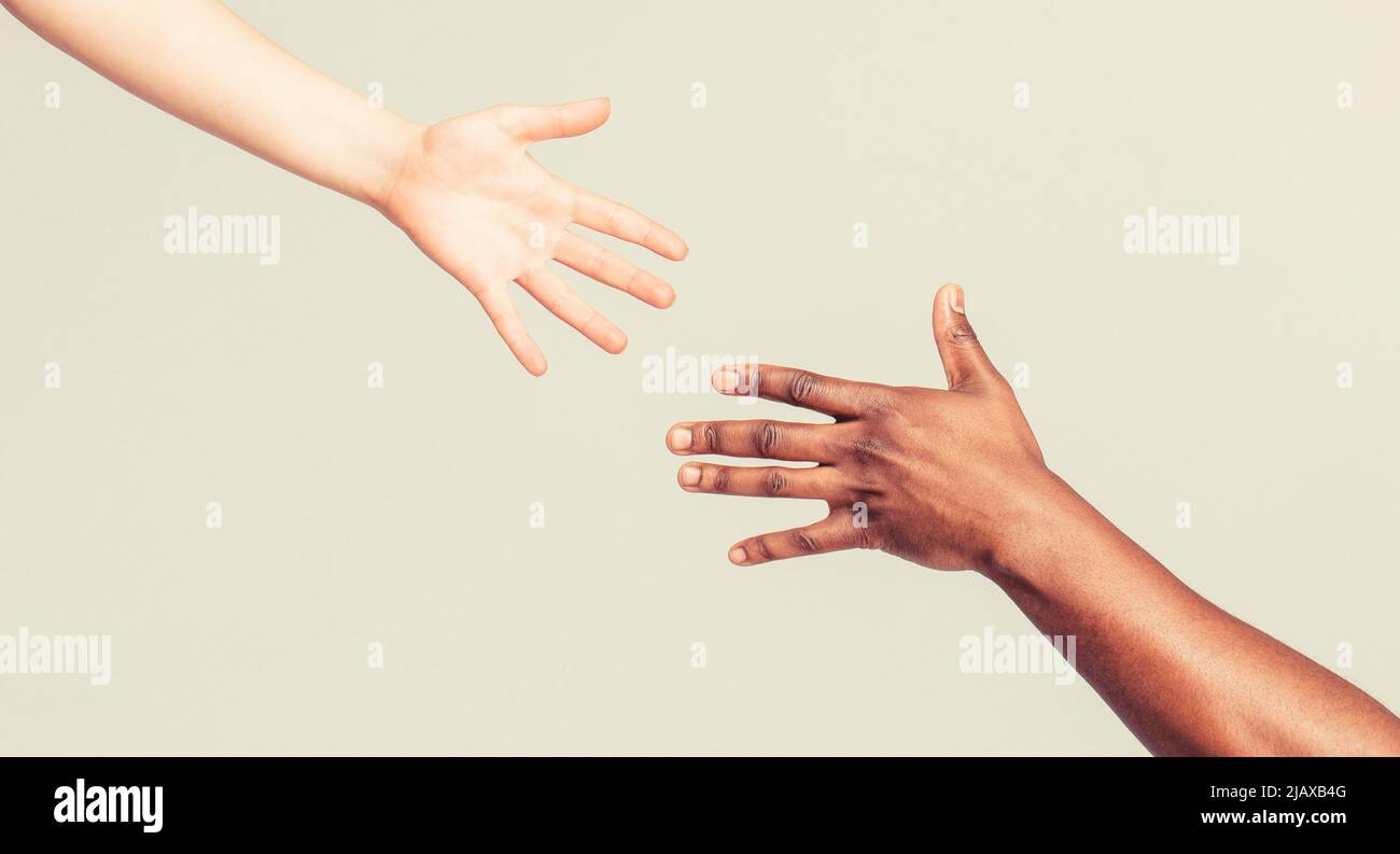 Giving a helping hand to another. Woman and african woman hand. Helping ...