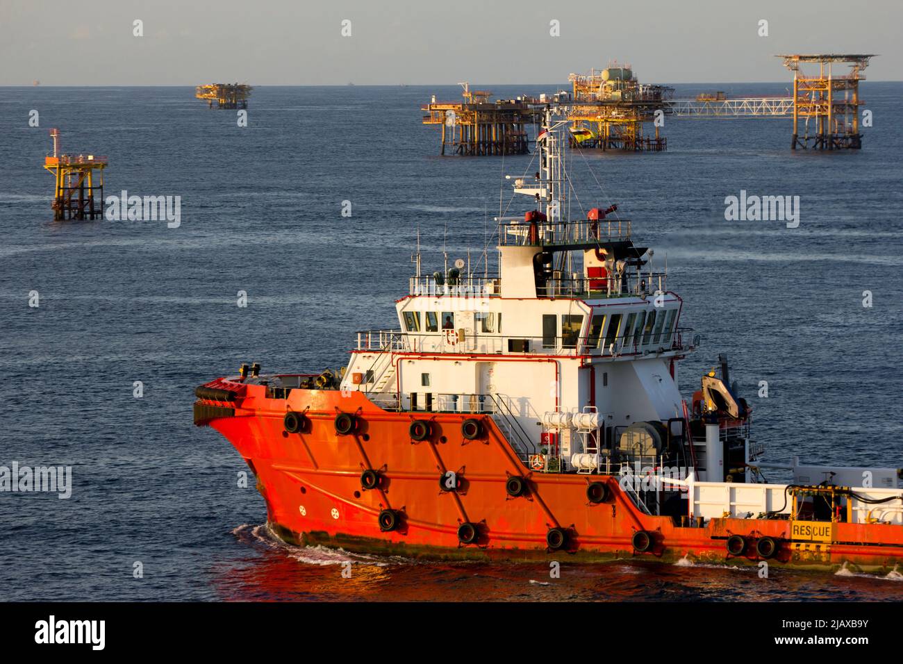 Oil rigs with supply boat boat for transporting people or materials to ...