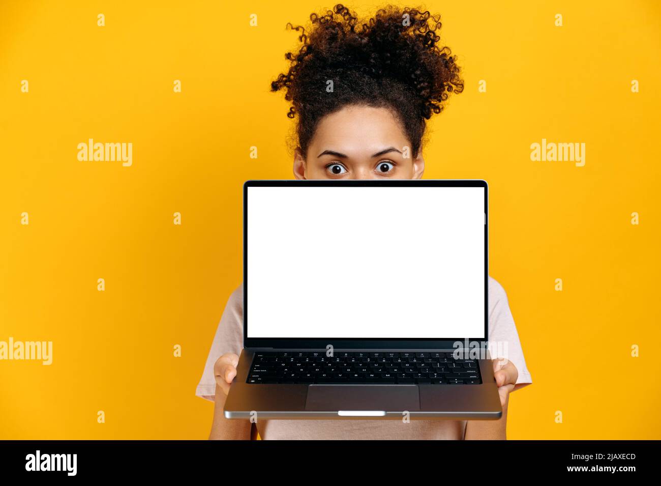 Amazed excited brunette african american girl peeking out from behind ...