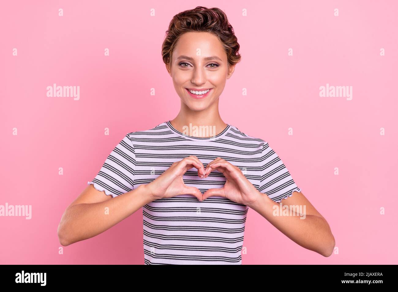 Photo of flirty young short hairdo lady show heart wear striped t-shirt ...