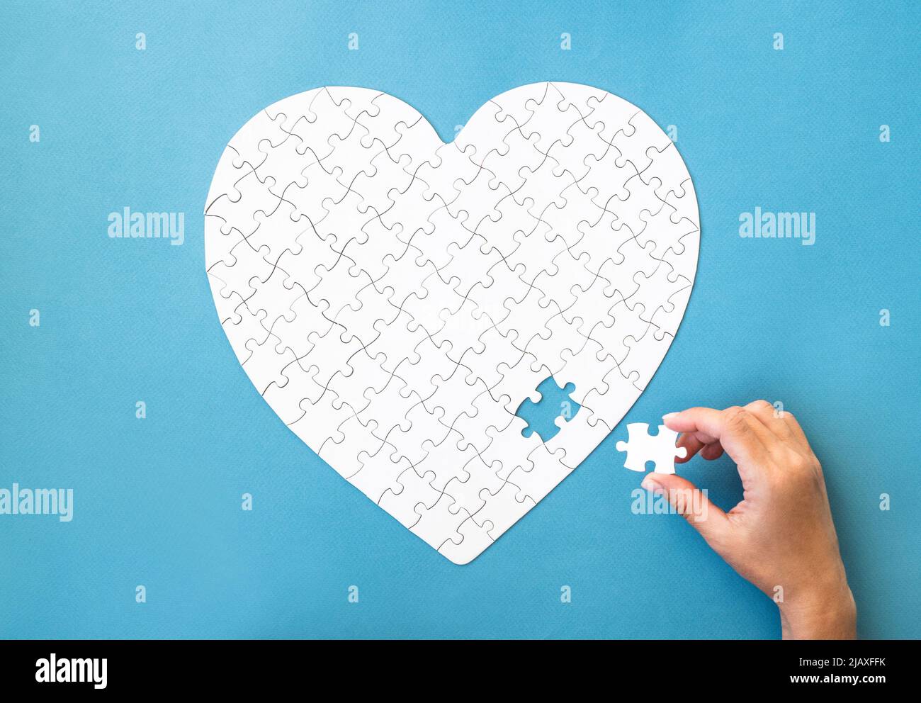 White puzzle in heart shape Stock Photo - Alamy
