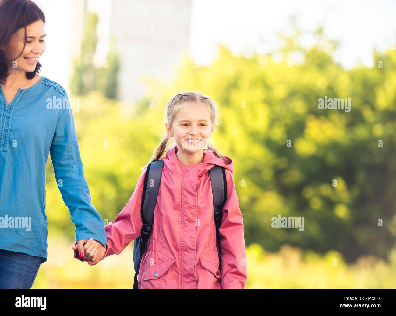 Little girl going to school with mother Stock Photo - Alamy