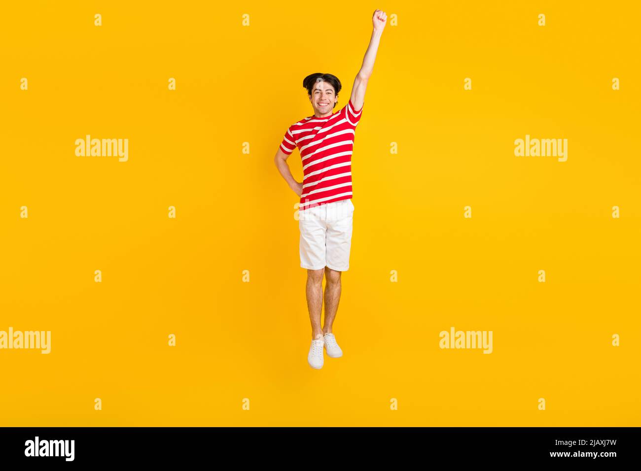 Full length photo of happy cheerful young raise hand super hero launch ...