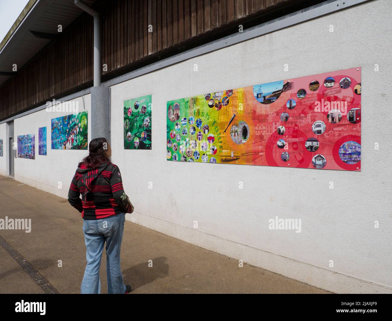 Woman looking at the public art on the New Fish Market wall, Brixham ...