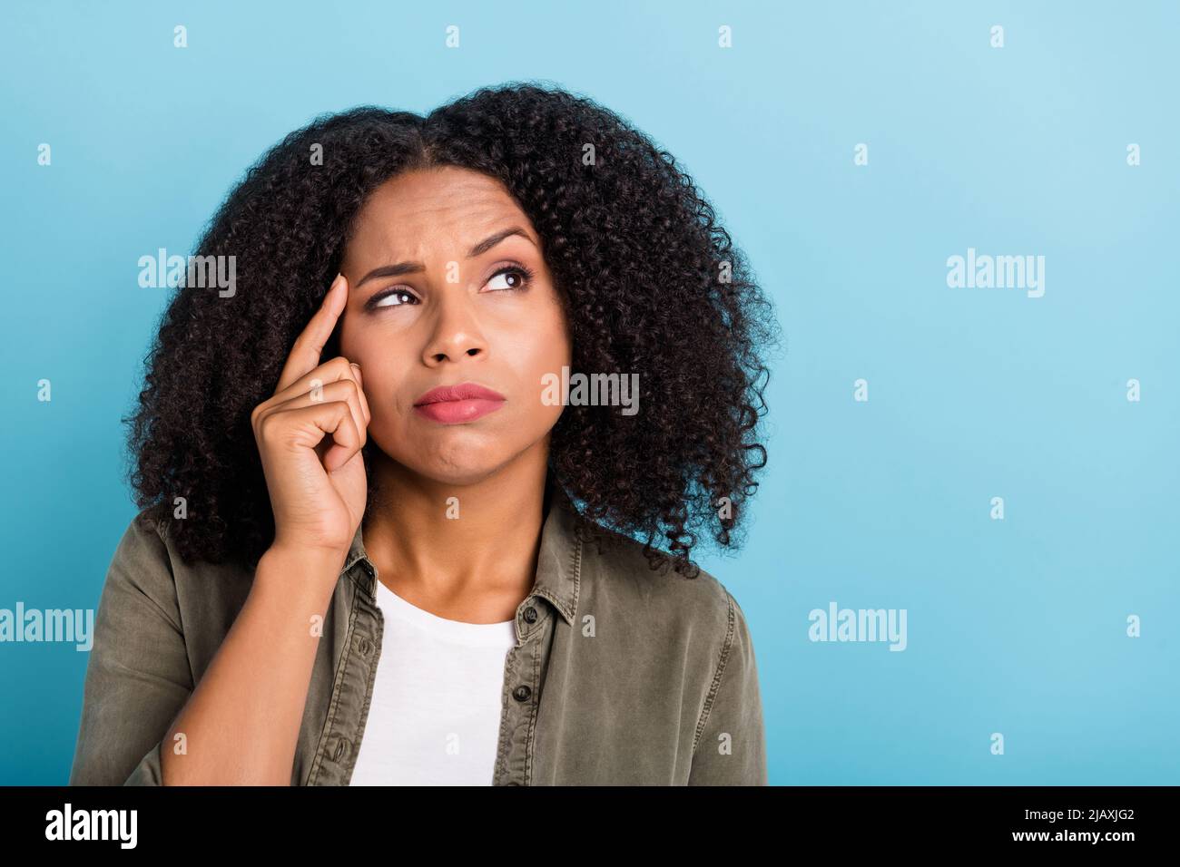 Portrait of minded concentrated lady finger touch temple look empty ...