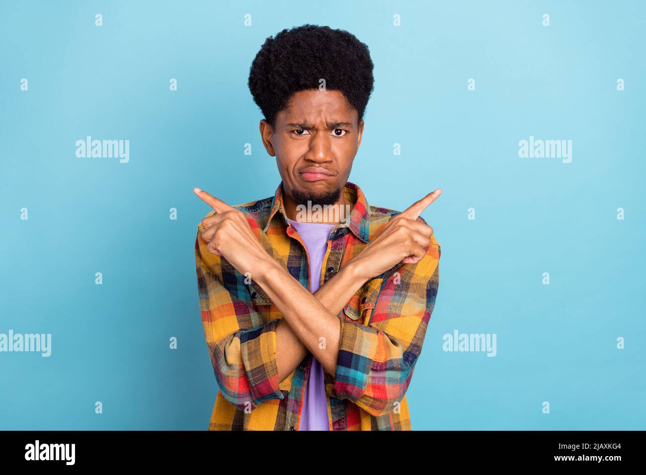 Photo of doubtful unsure dark skin guy dressed checkered shirt pointing ...