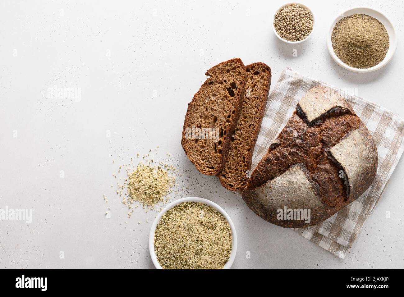 Hemp bread and organic hempseeds on white background. Copy space. Top ...