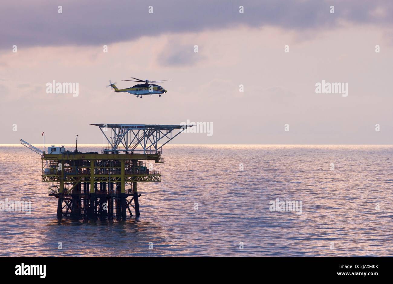 A helicopter on top of a offshore oil-platform transporting roughnecks ...