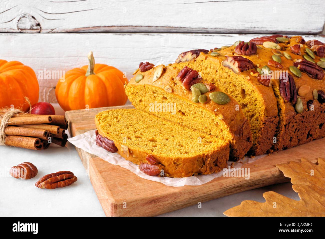 Fall pumpkin bread. Slices close up against a white table scene ...