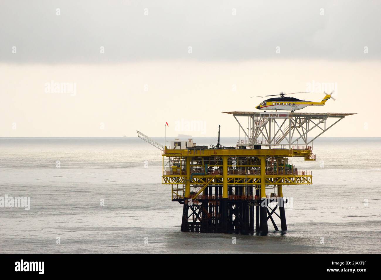 A helicopter on top of a offshore oil-platform transporting roughnecks ...