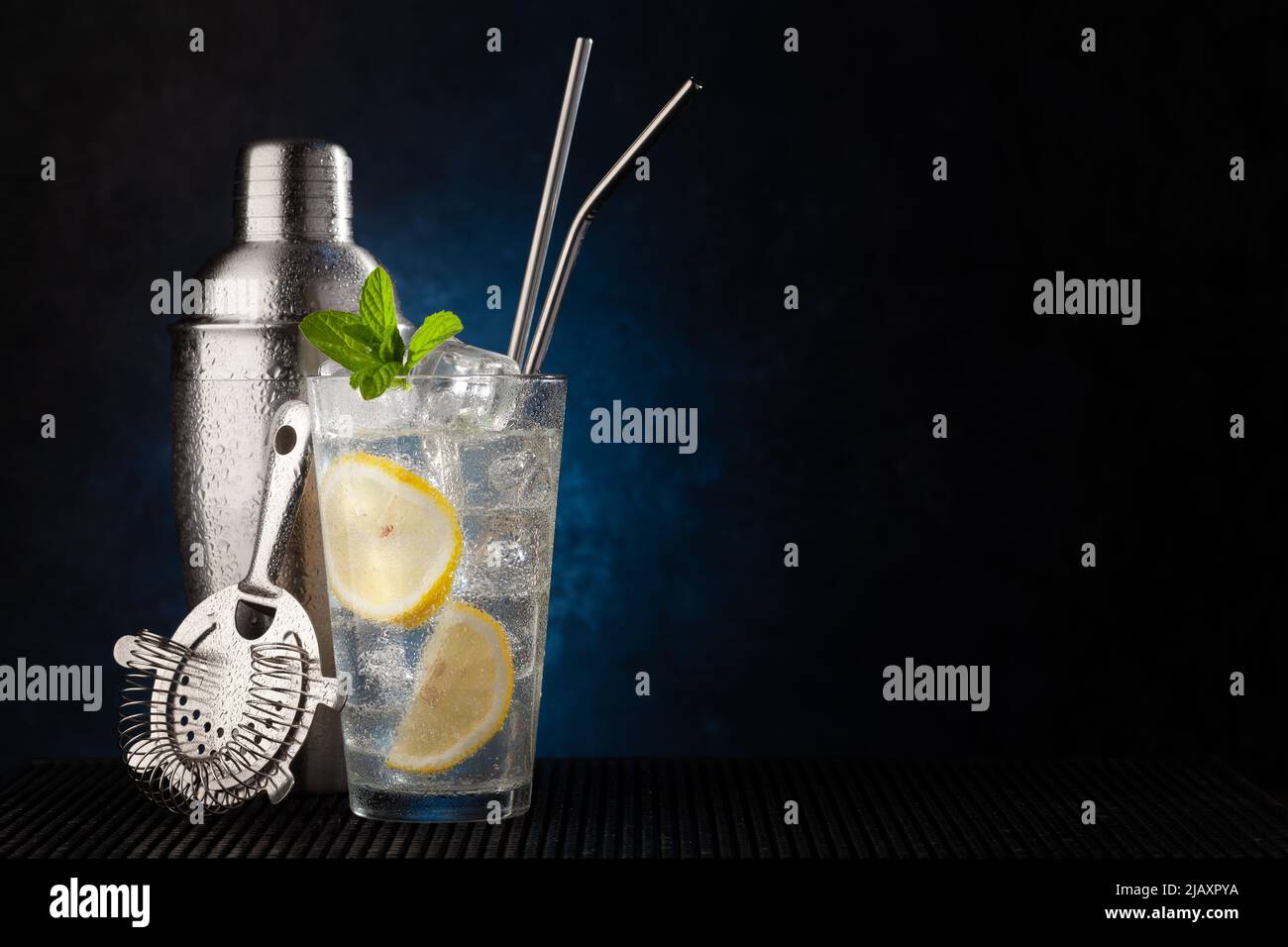 Cocktail shaker and gin tonic cocktail on dark background with copy ...