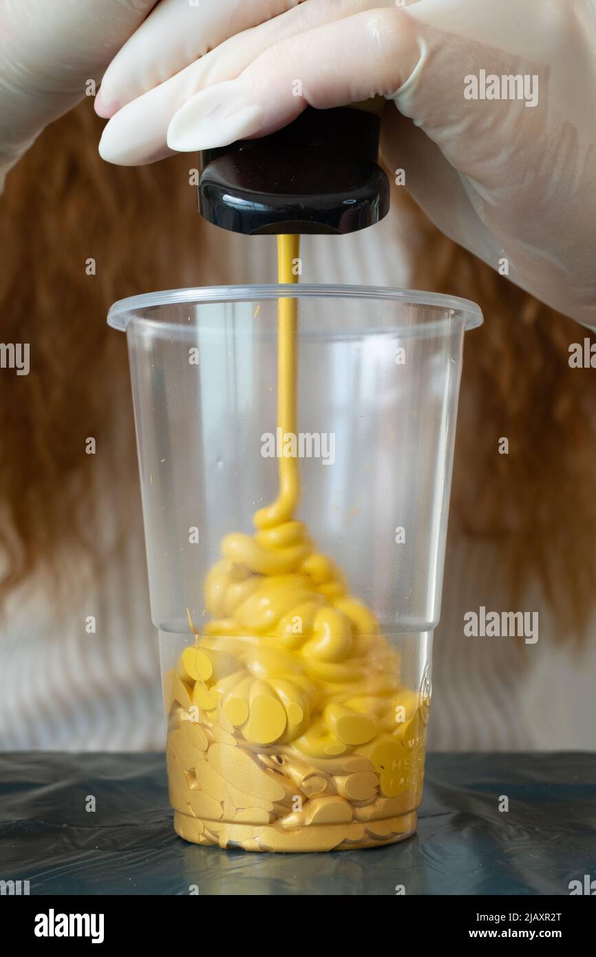 Fluid art technique. Female artist works on abstract fluid art painting ...