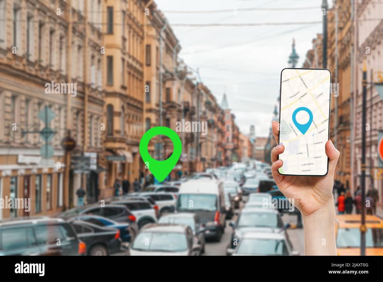 A female's hand holds a smartphone with an online map app. In the ...