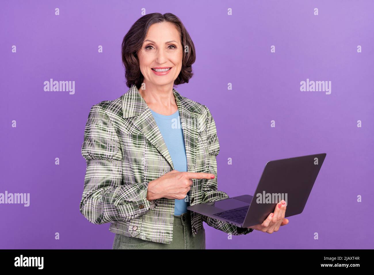 Photo of cool happy retired pensioner old woman point finger hold hands ...
