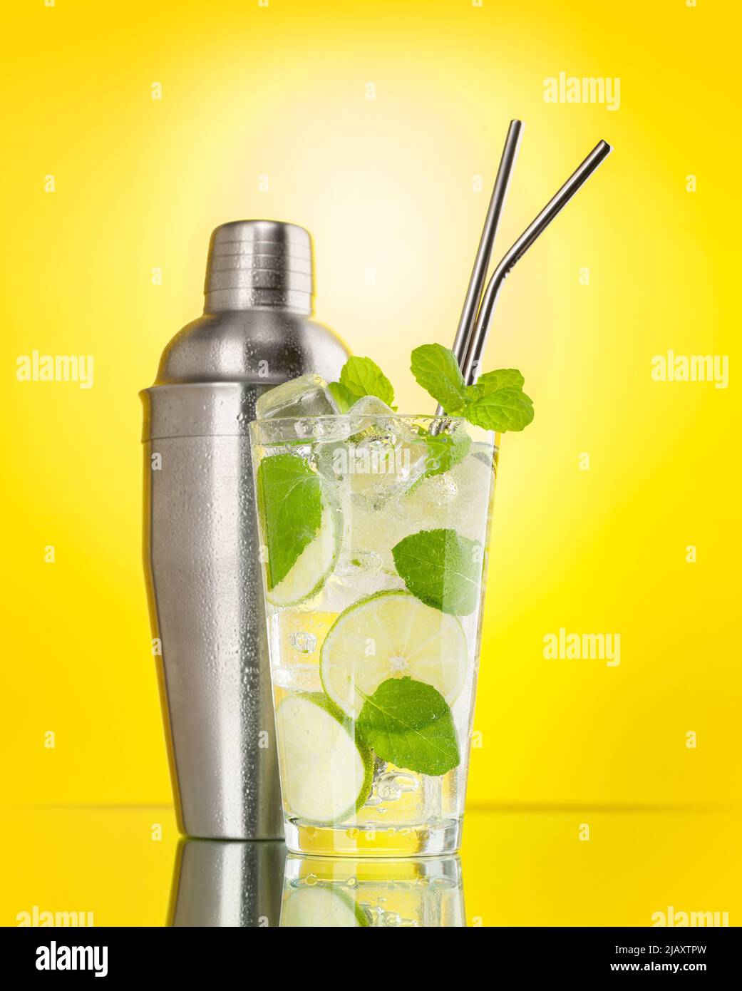 Mojito cocktail and cocktail shaker on yellow background Stock Photo ...