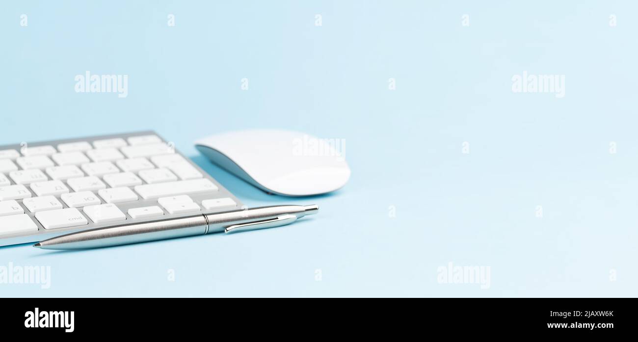 Pc keyboard, mouse and pen on blue background with copy space Stock ...