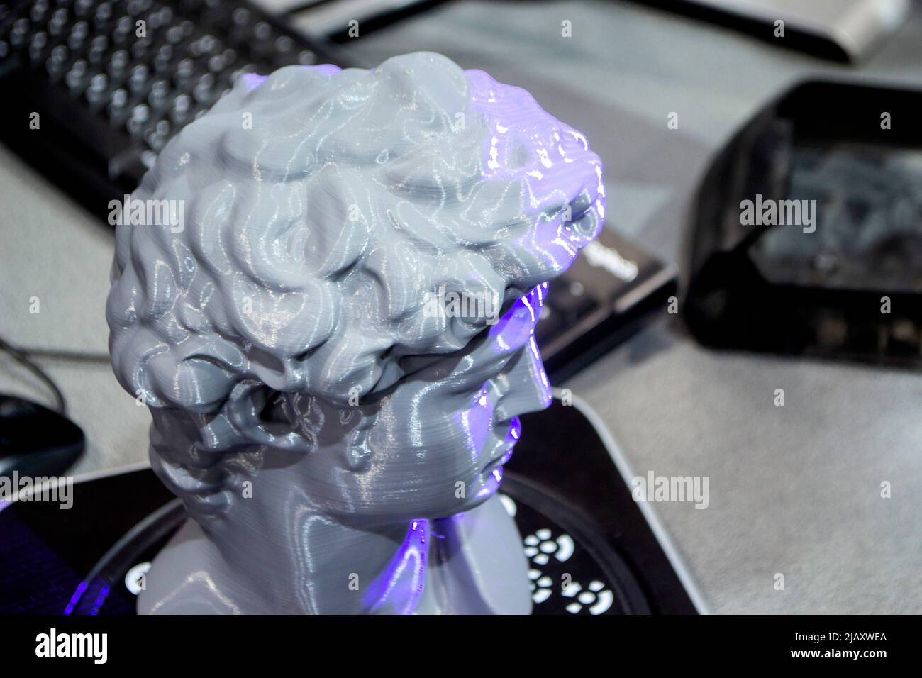 Gray human head on 3d printed close-up. An object prototype of a human ...