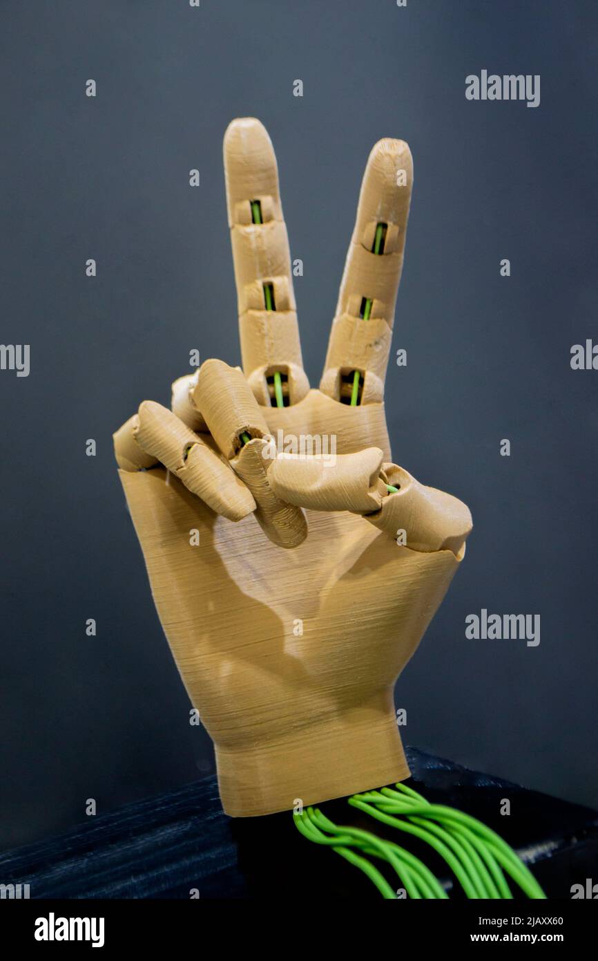 Brown human hand on 3d printed close-up. An object prototype of a human ...