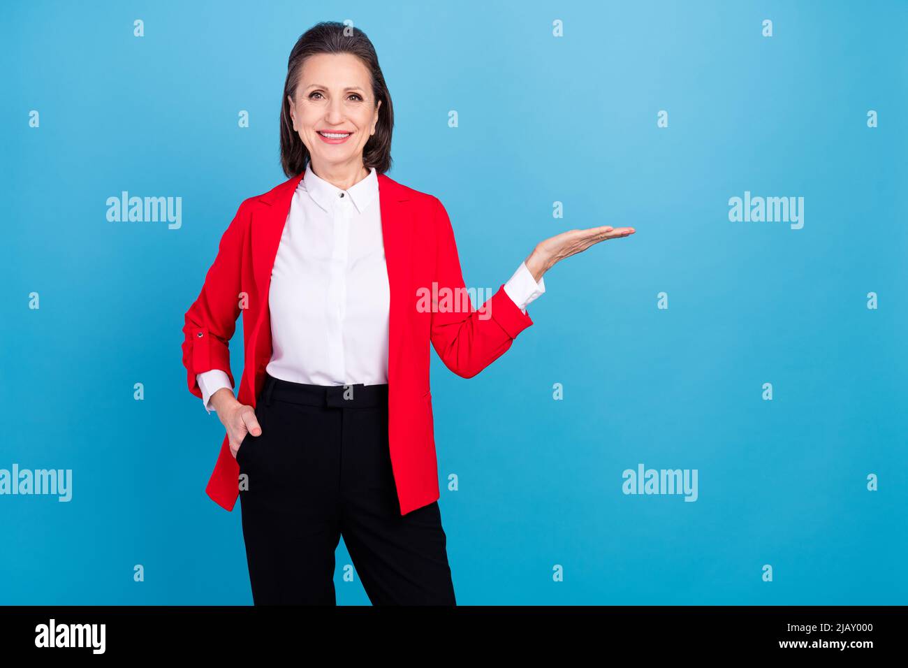 Portrait of attractive cheery businesswoman holding on palm copy space ad solution isolated over ...