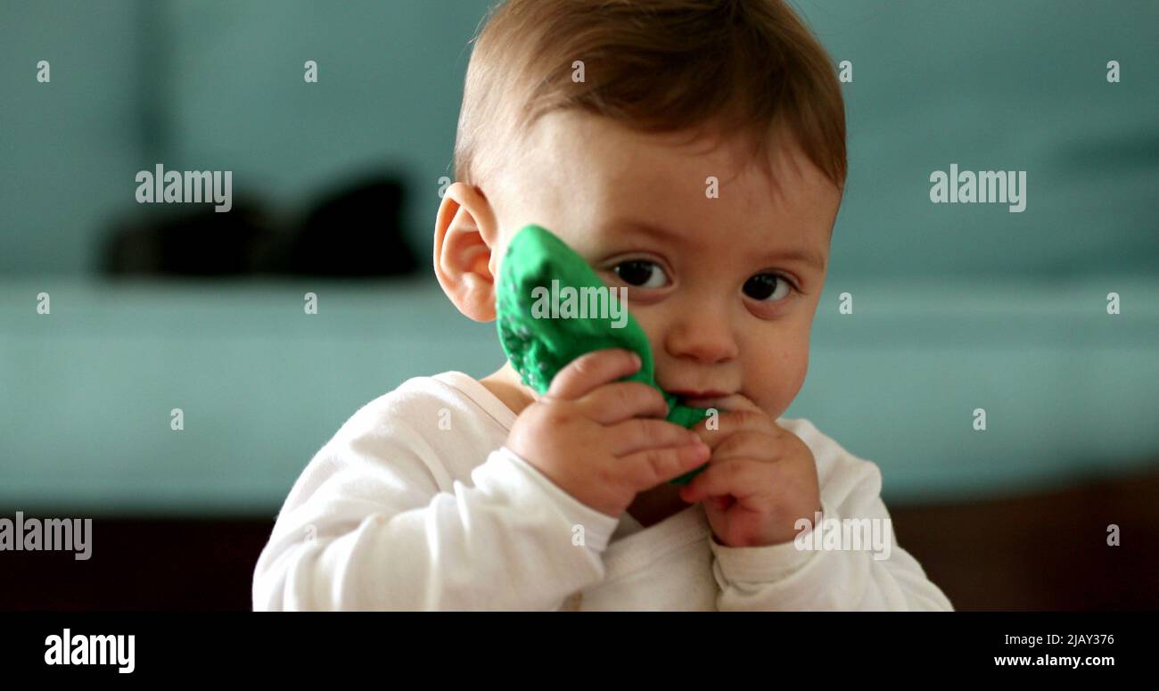 Cute baby putting sock in mouth. Infant child chewing clothing Stock ...