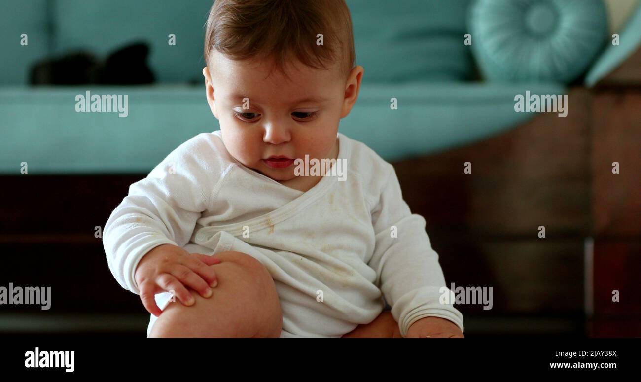 Cute baby toddler infant child on play mat wanting to bite his own feet ...