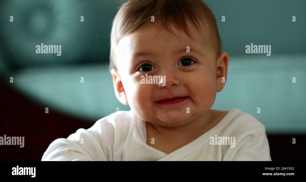 Cute happy baby eating apple fruit snack, infant smiling and laughing ...