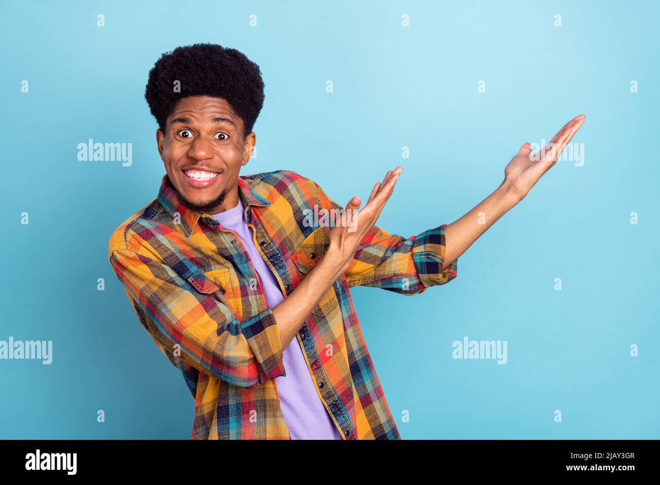 Photo of funny millennial brunet guy point empty space wear checkered ...