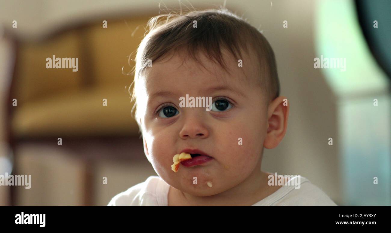 Infant baby spitting apple fruit out of mouth Stock Photo - Alamy