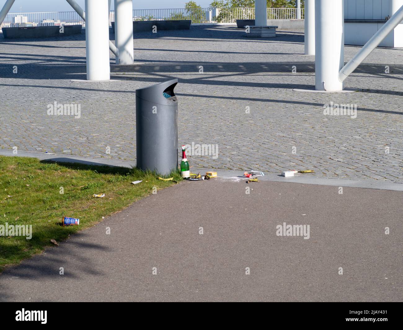 Scattered garbage around the trash can in the park. trash scattered ...