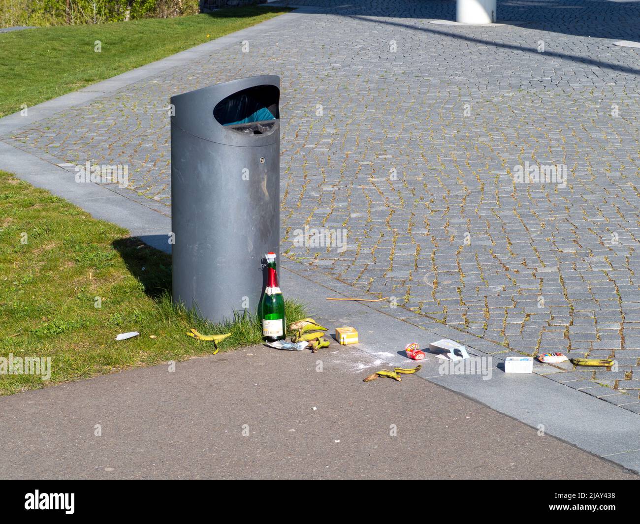 Scattered garbage around the trash can in the park. trash scattered ... Scattered garbage around the trash can in the park. trash scattered ...