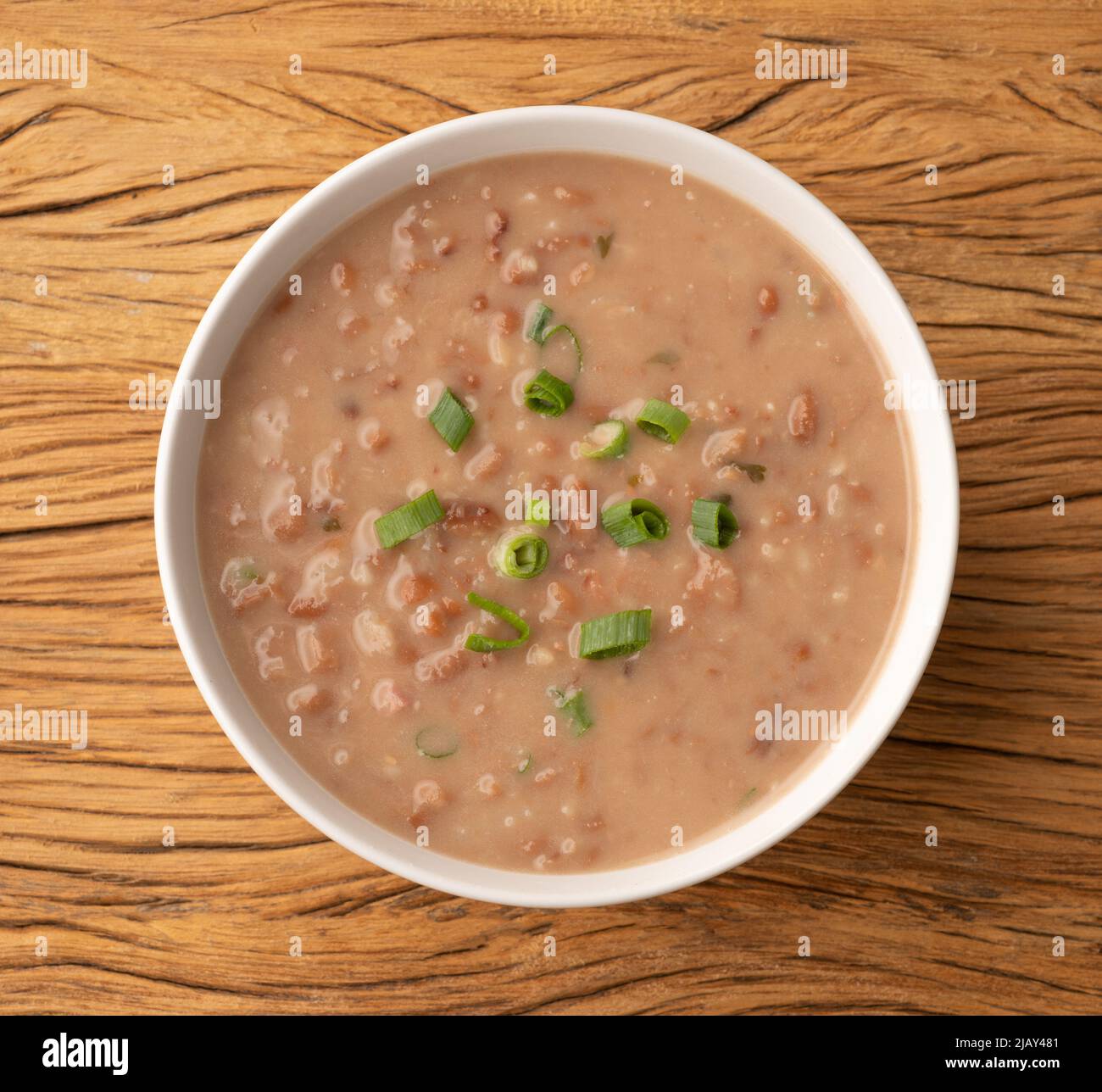 Brown bean soup in a bowl over wooden table Stock Photo - Alamy