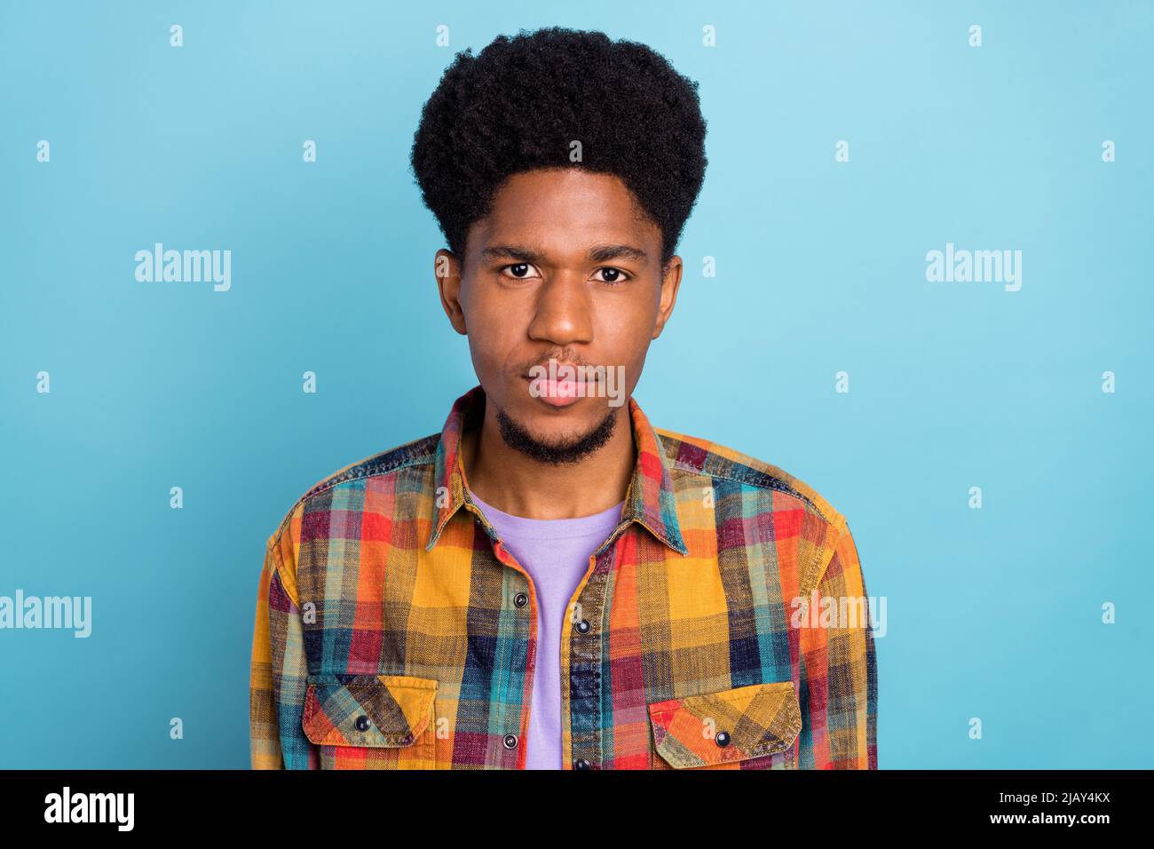 Photo of good young brunet guy wear yellow shirt isolated on blue color ...
