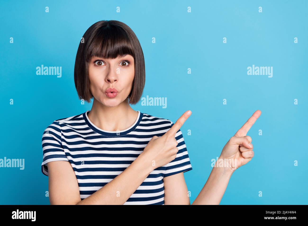 Photo of funny brunette young lady point empty space wear striped t ...