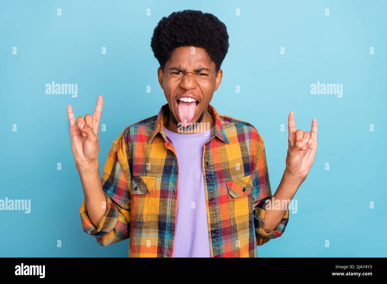 Photo of cool young brunet guy show rock sign wear yellow shirt ...