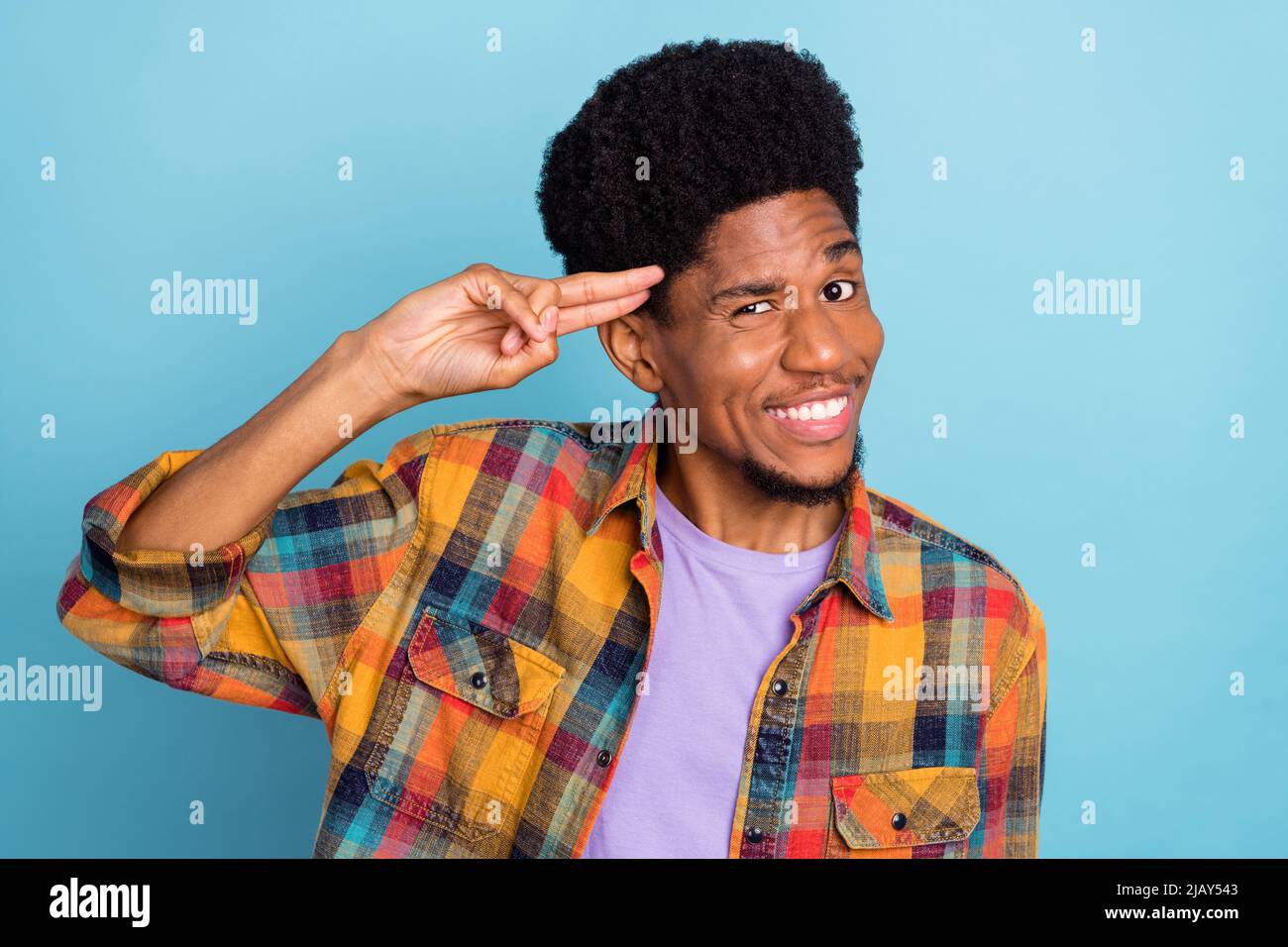 Photo of funny young brunet guy point head wear checkered shirt ...