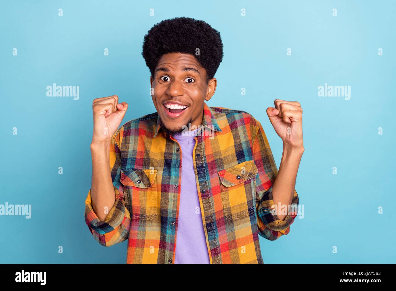 Photo of hooray millennial brunet guy hands fists wear checkered shirt ...