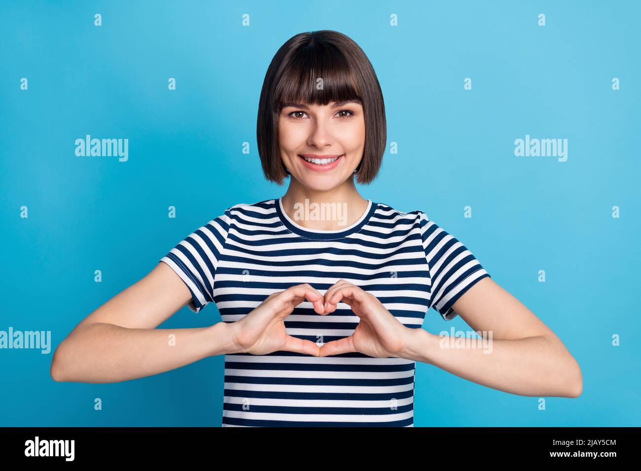 Photo of coquette brunette young lady show heart wear striped t-shirt ...