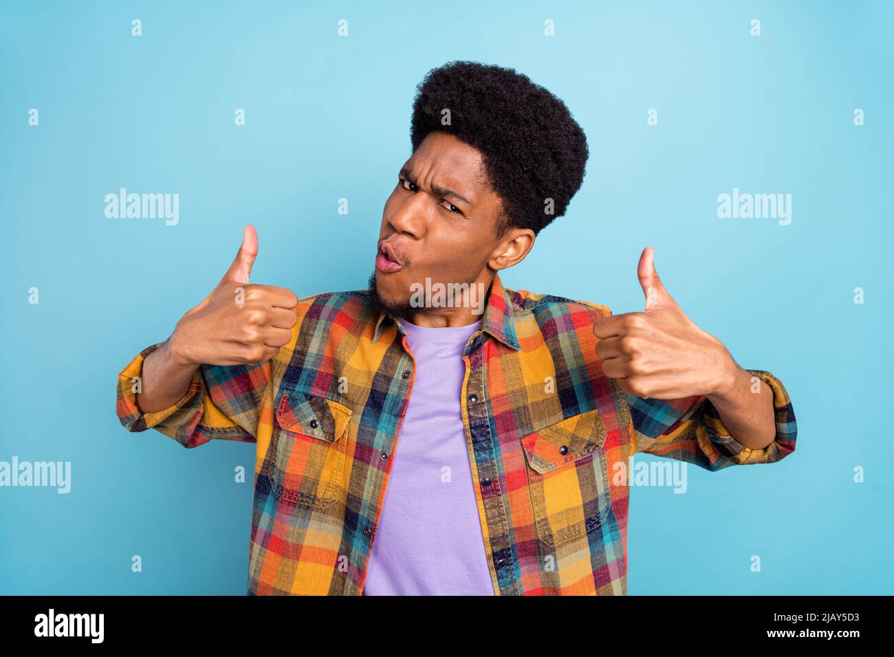 Photo of cool millennial brunet guy show thumb up wear yellow shirt ...